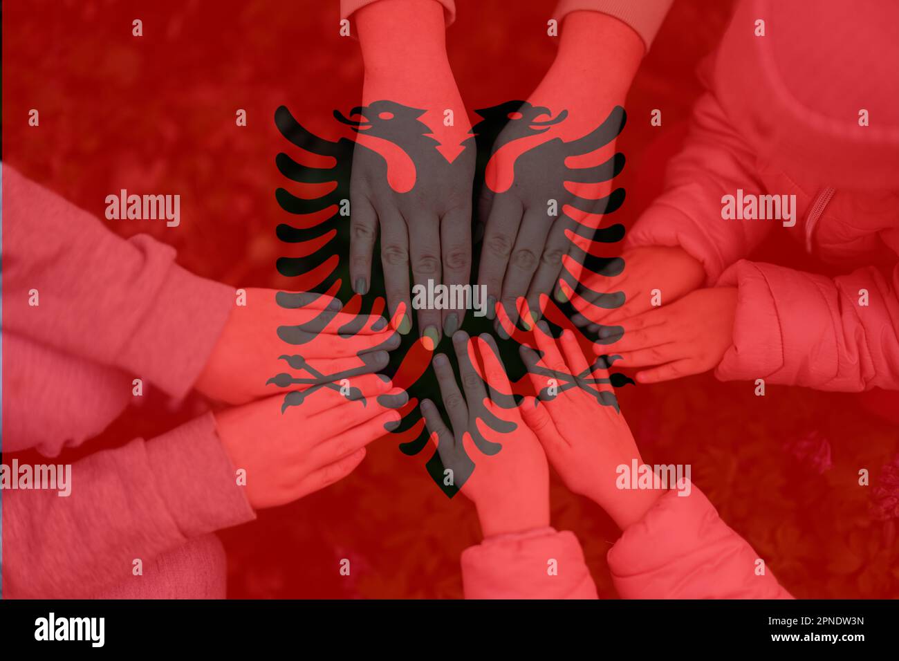Hands of kids on background of Albania flag. Albanian patriotism and ...