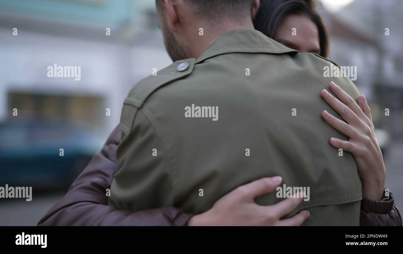 Couple embrace standing in street in empathic hug. Caring and ...