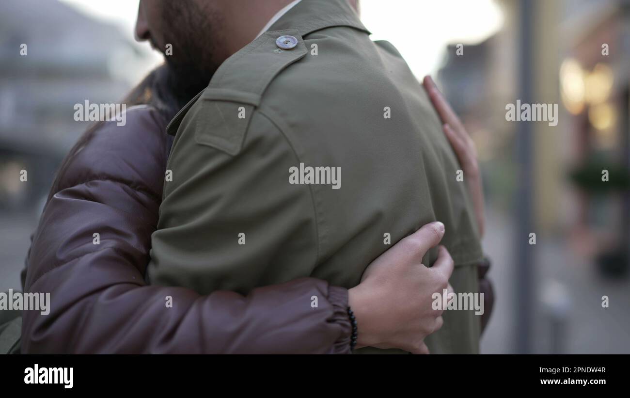 Couple embrace standing in street in empathic hug. Caring and ...