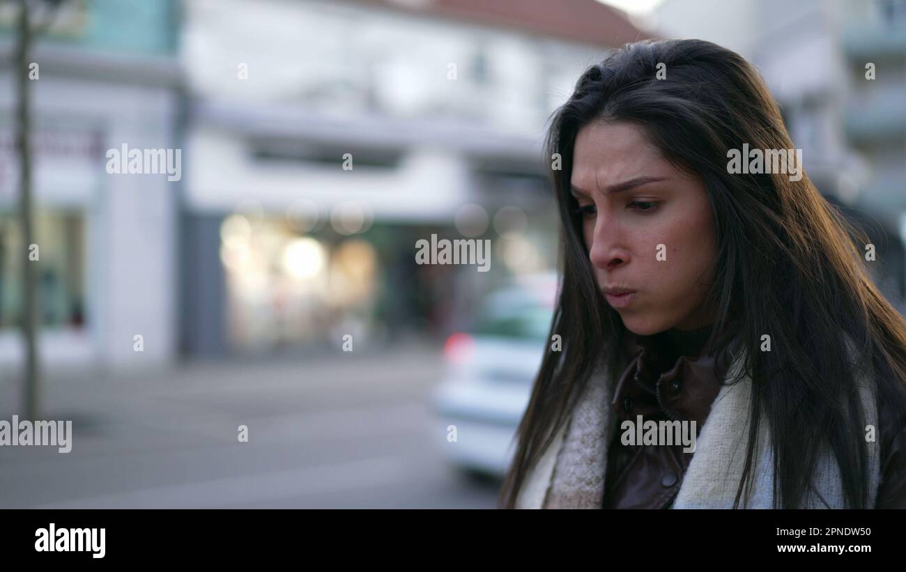 Frustrated young walking in city street feeling disbelief. Female ...