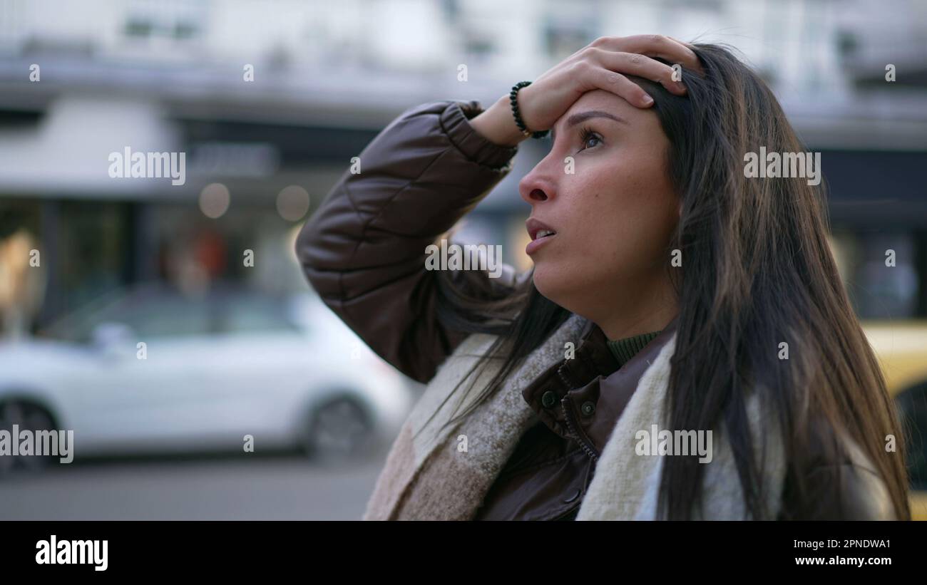 One anxious Middle Eastern young woman walking in street feeling ...