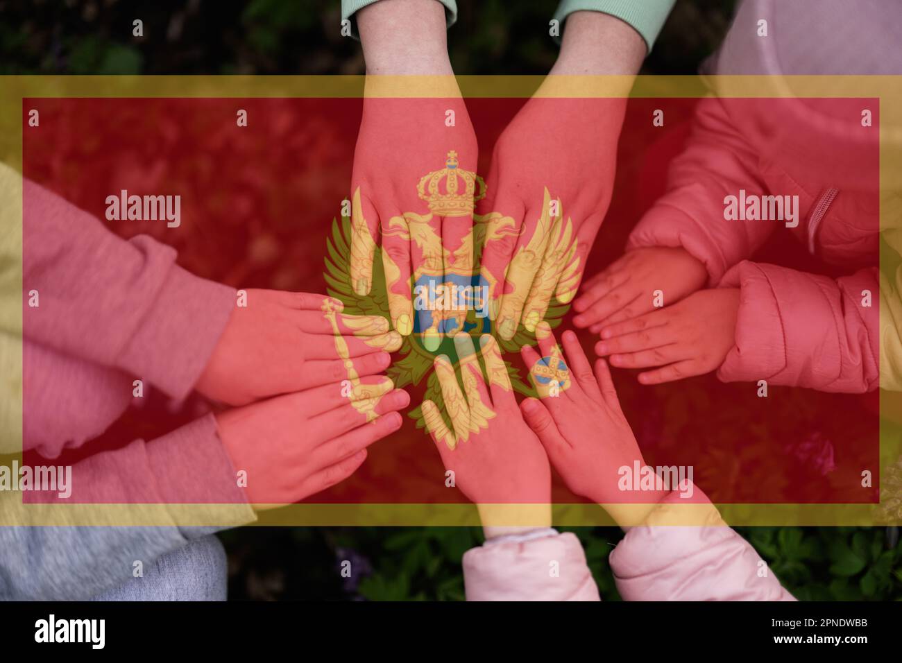Hands of kids on background of Montenegro flag. Montenegrin patriotism ...