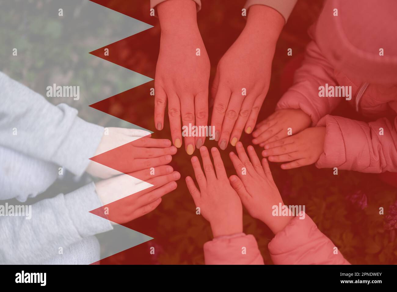 Hands of kids on background of Bahrain flag. Bahraini patriotism and ...