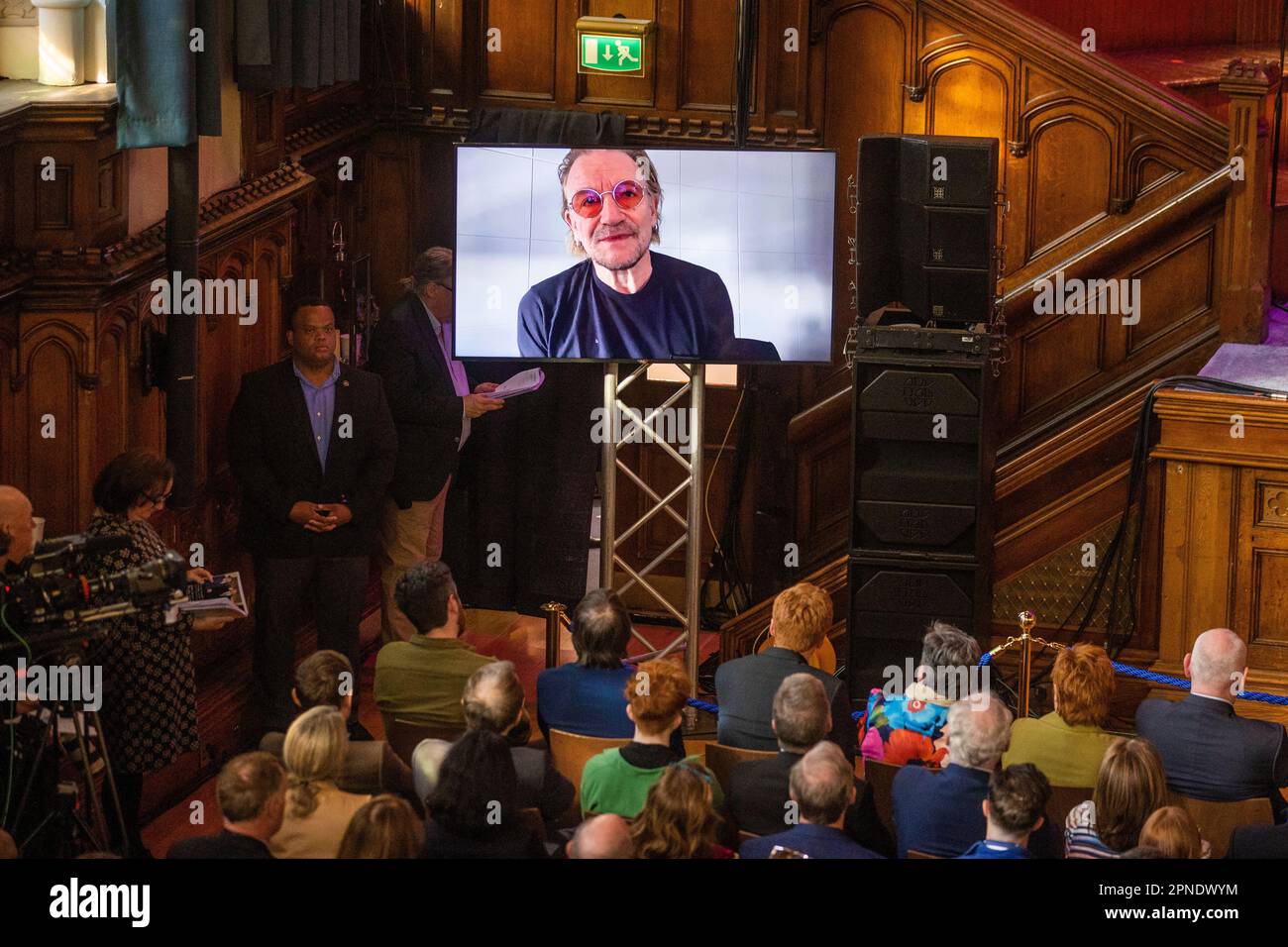 A pre-recorded video of U2 frontman Bono shown on screen before former ...