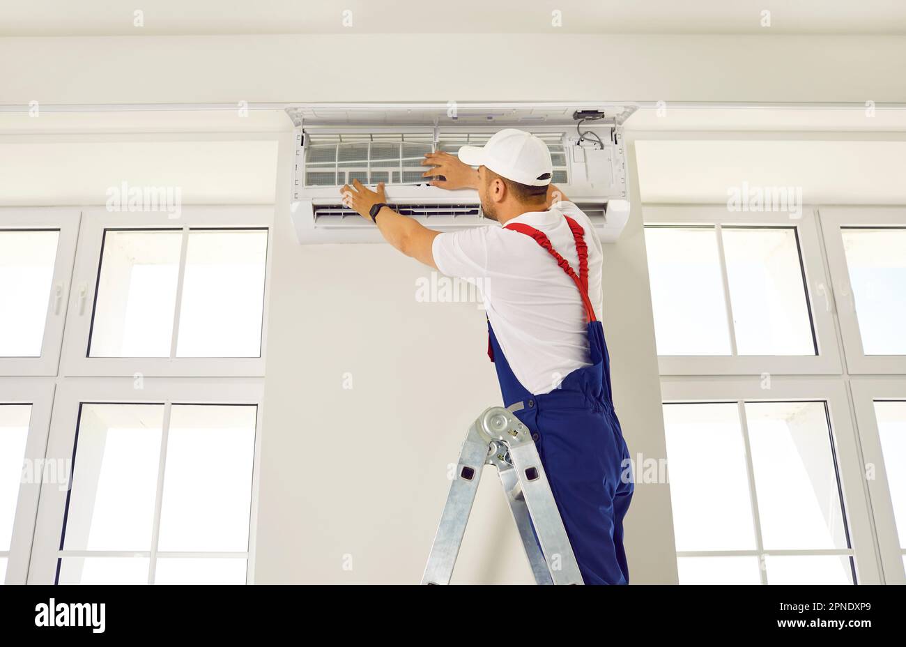 Worker installs ventilation system hi-res stock photography and images ...