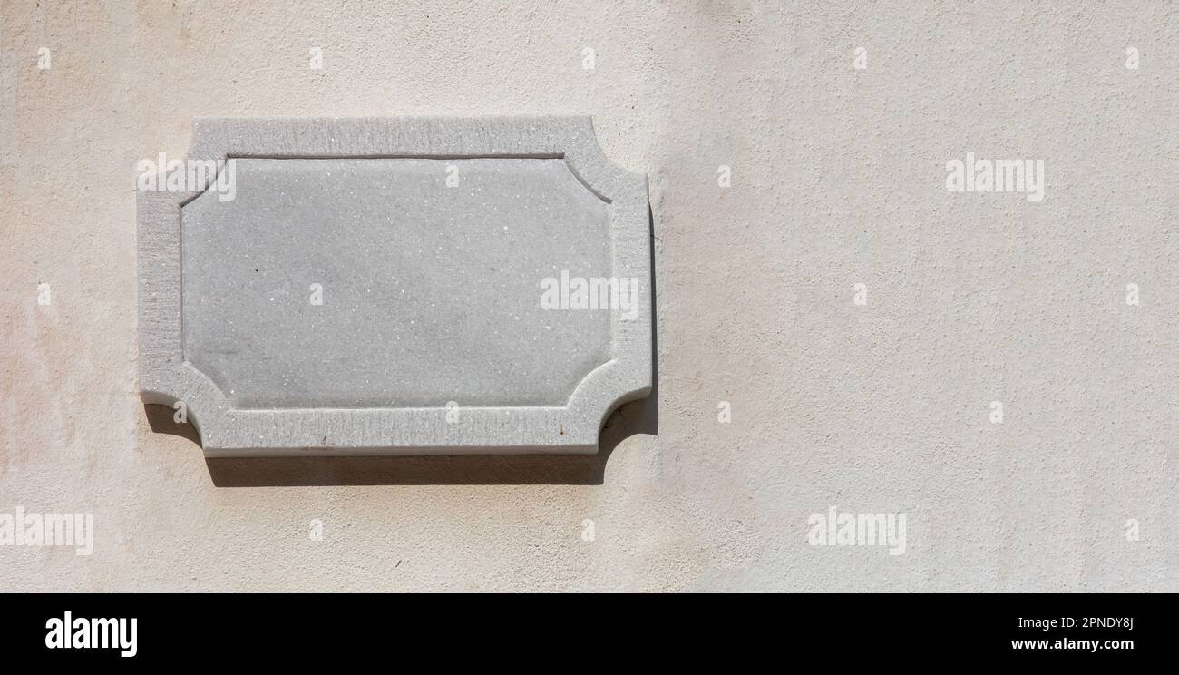 Marble sign blank on wall. White empty label, copy space, template ...