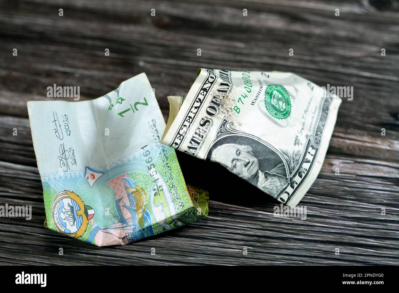 Wrinkled and crumpled Kuwaiti half KWD dinar bill banknote and 1 one ...
