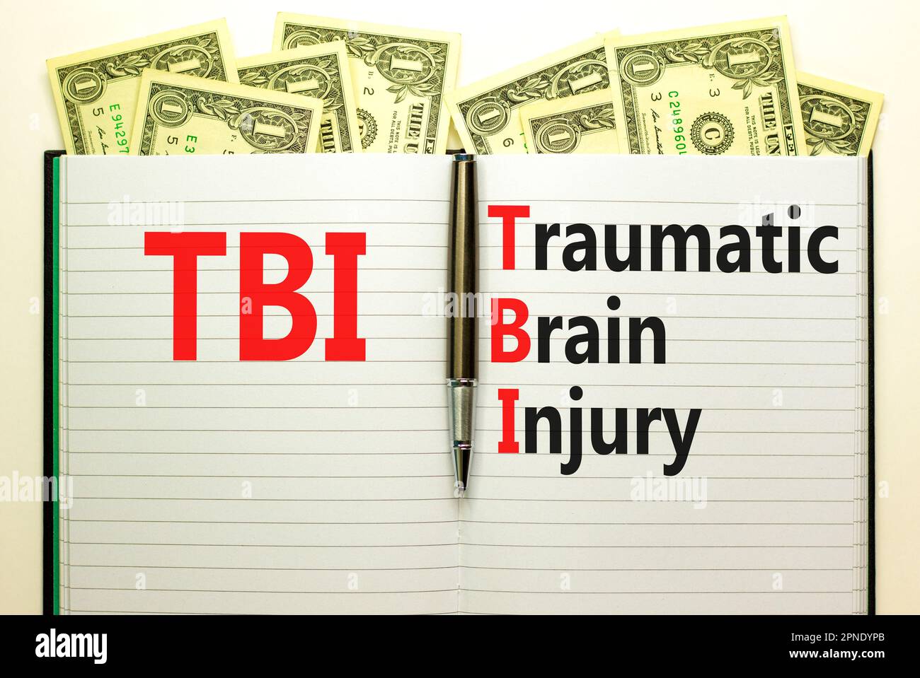 TBI traumatic brain injury symbol. Concept words TBI traumatic brain injury on white note on a ...