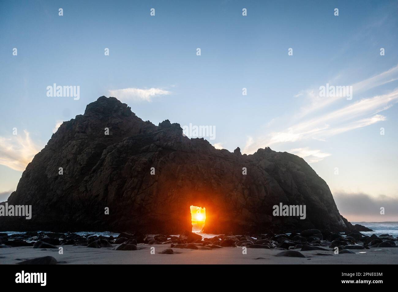Wide-angle shot of the keyhole arch at Pfeiffer beach, California, whit ...