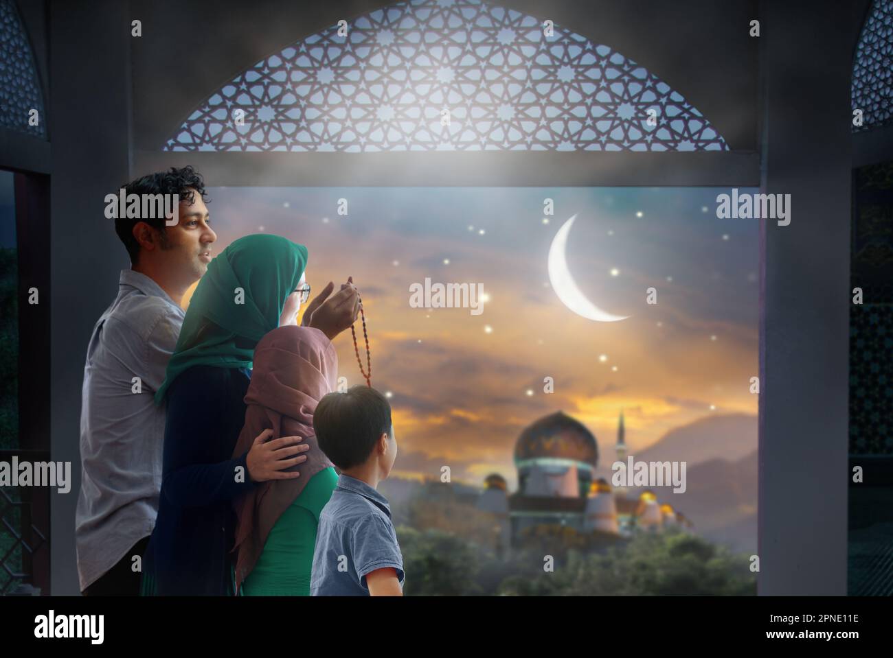 Ramadan Kareem greeting. Family at window looking at Islamic city with ...