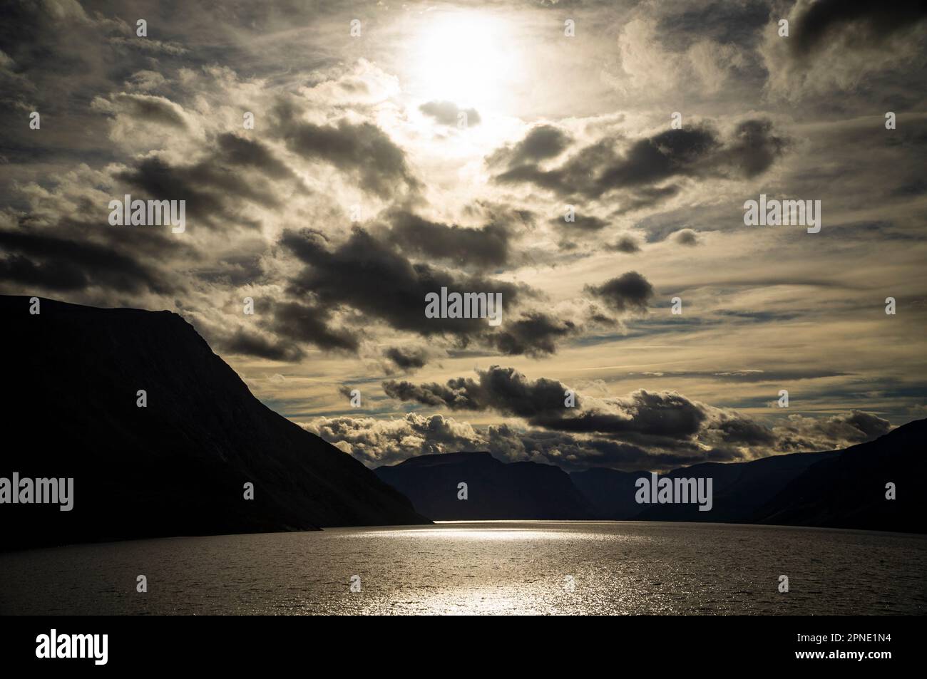 Saglek Fjord in silhouette of the late day sun in northern Labrador ...
