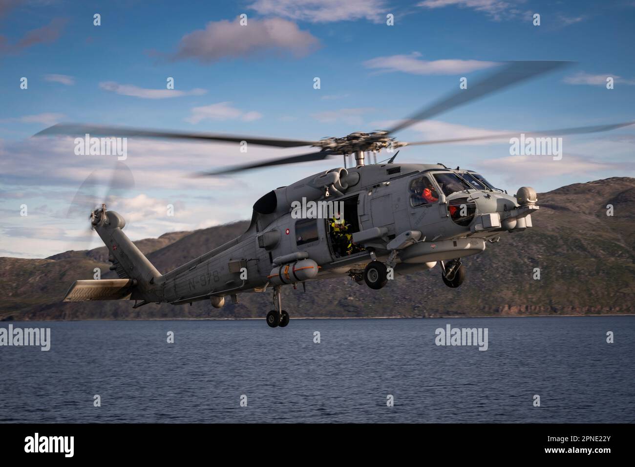Royal Danish Navy Sikorsky MH-60R Seahawk helicopter performing a flypast in Saglek Fjord ...