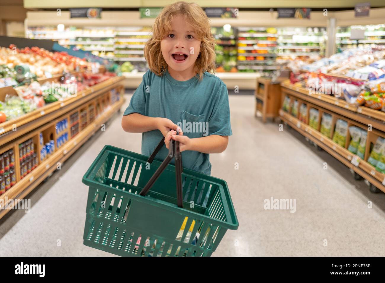 Child with shopping basket. Shopping in supermarket. Kids buying ...
