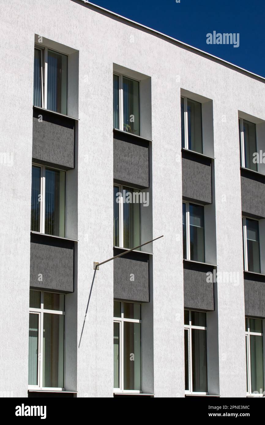 The windows of the white three-story building and the blue sky Stock ...
