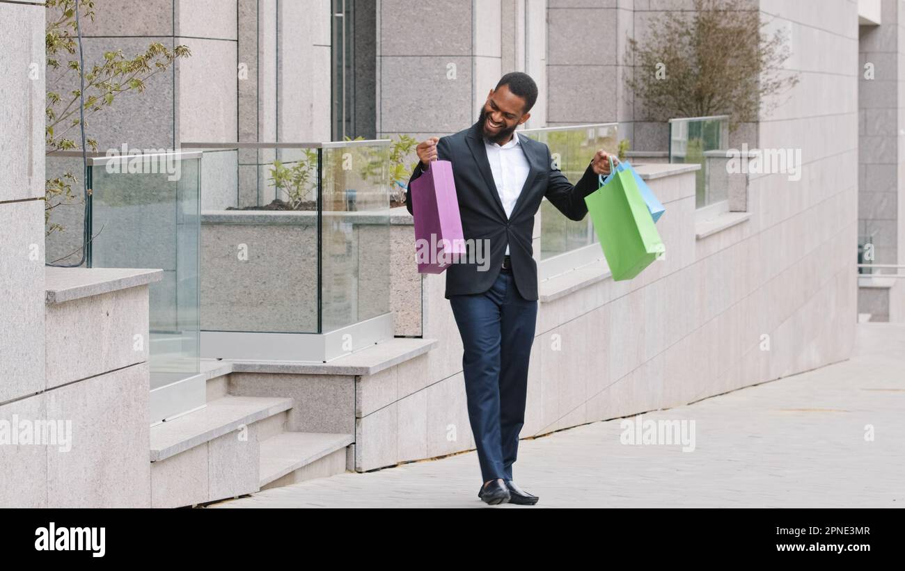 Male ethnic customer client buyer man holding shopping bags buying in ...