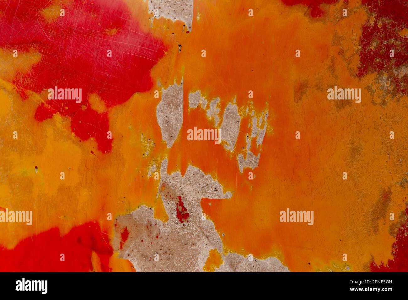 Abstract image from a public park slide with faded orange, red and ...