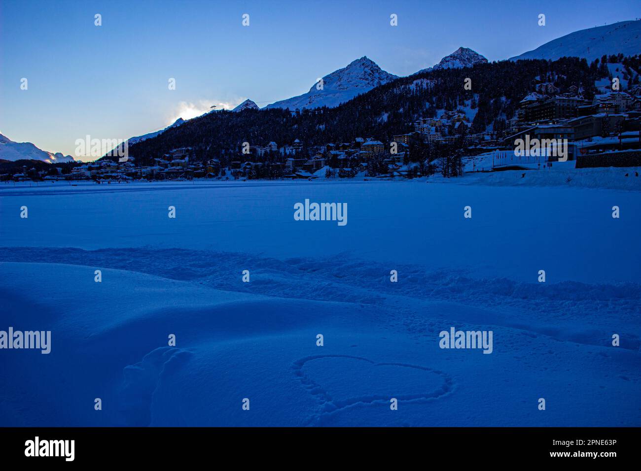 Magnificent sunset in the snowy Swiss Alps overlooking the city of St ...