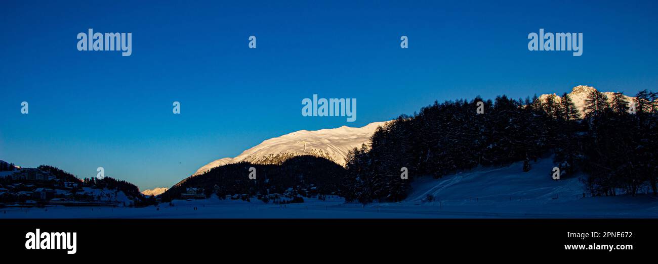 Magnificent sunset in the snowy Swiss Alps overlooking the city of St ...