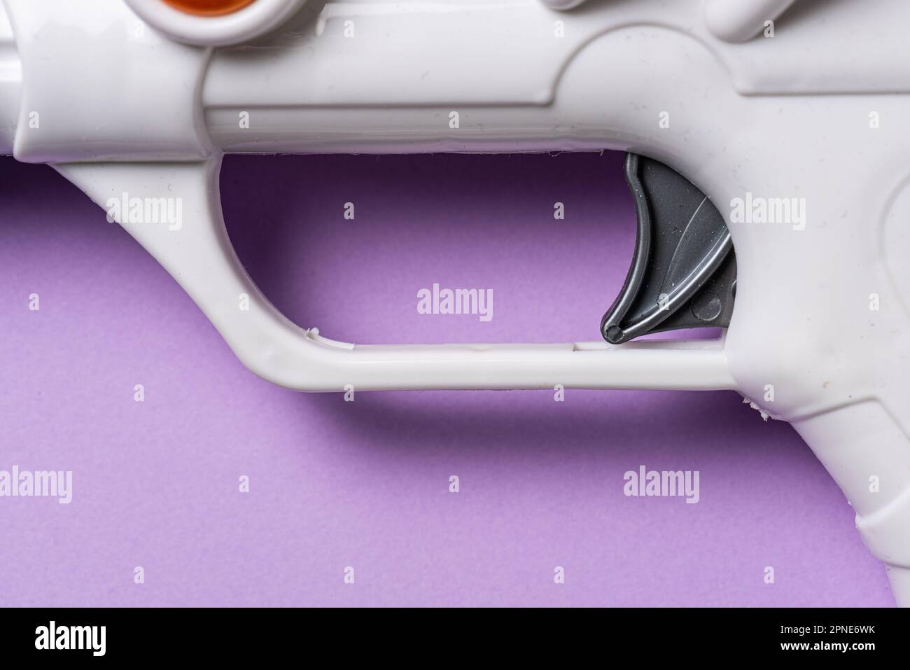 Detail of the trigger of a water gun Stock Photo - Alamy