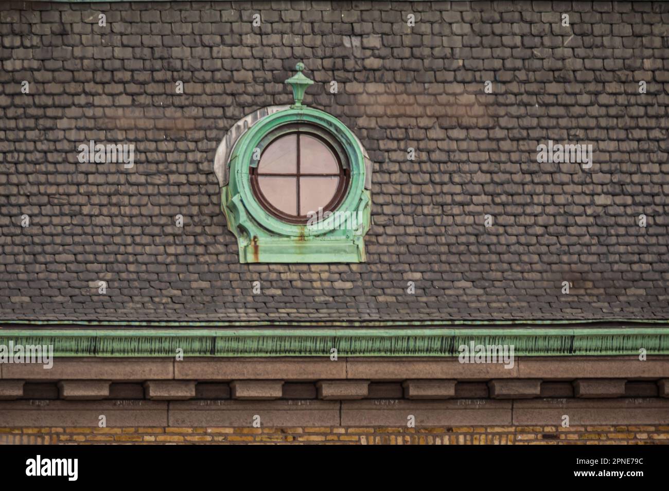 Round window in the roof of a hotel Stock Photo - Alamy