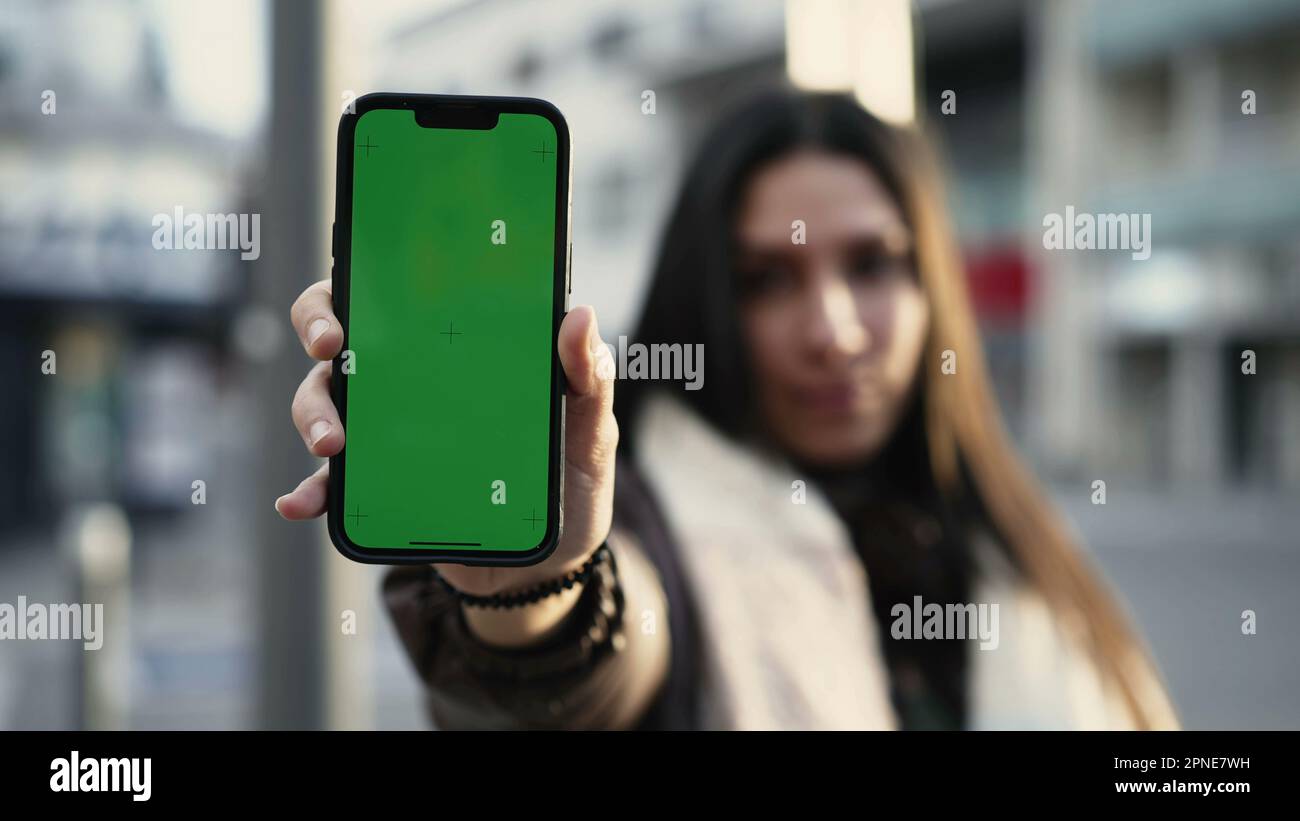 Female presenter displaying digital content on Chroma Key Greenscreen ...