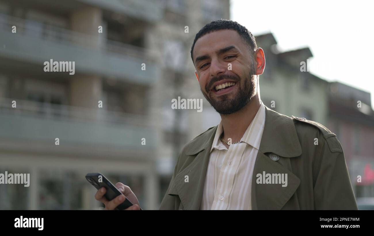 Happy young man laughing and smiling closeup face standing in city ...