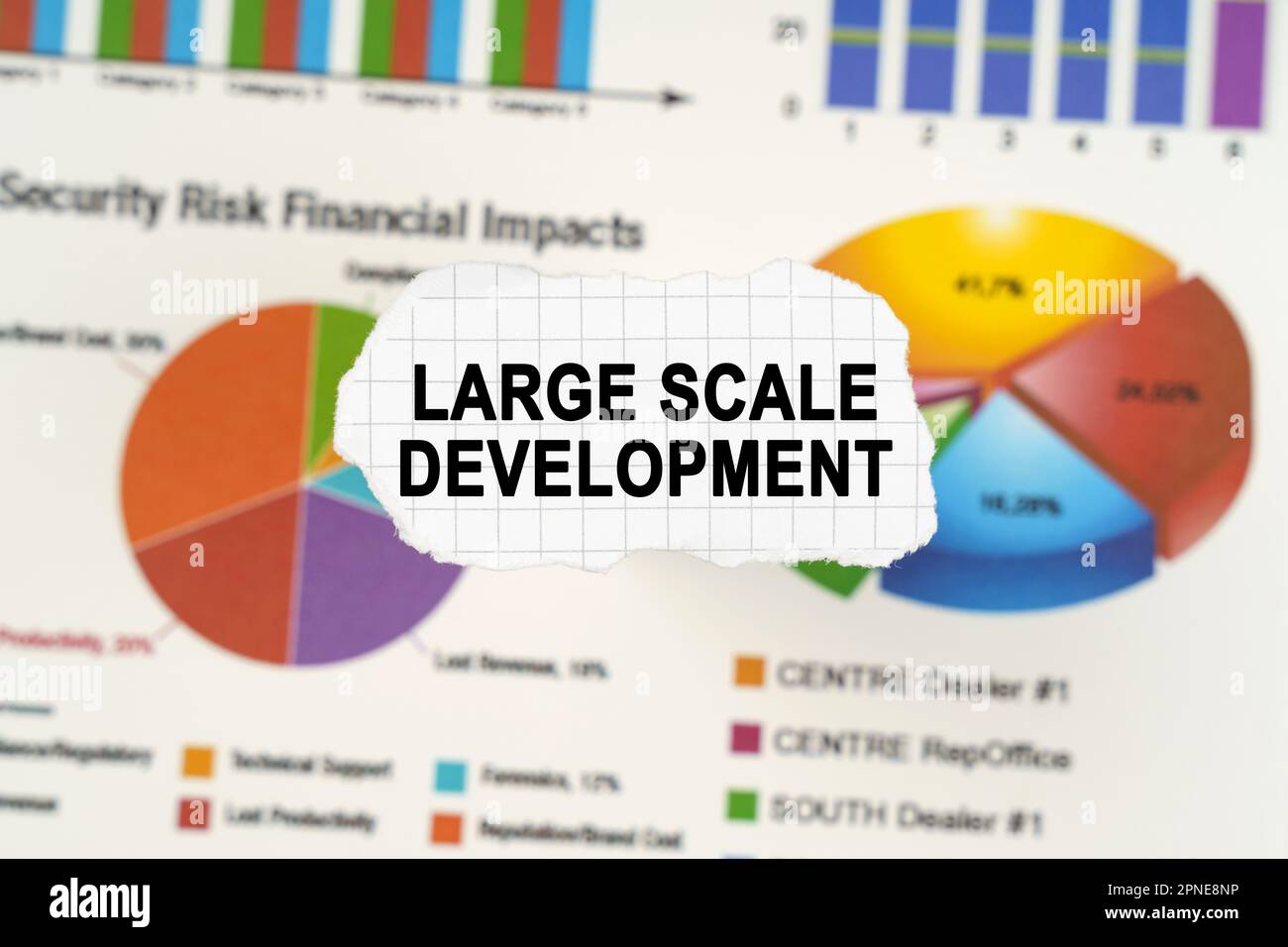 Business concept. On diagrams and graphs lies torn paper with the ...