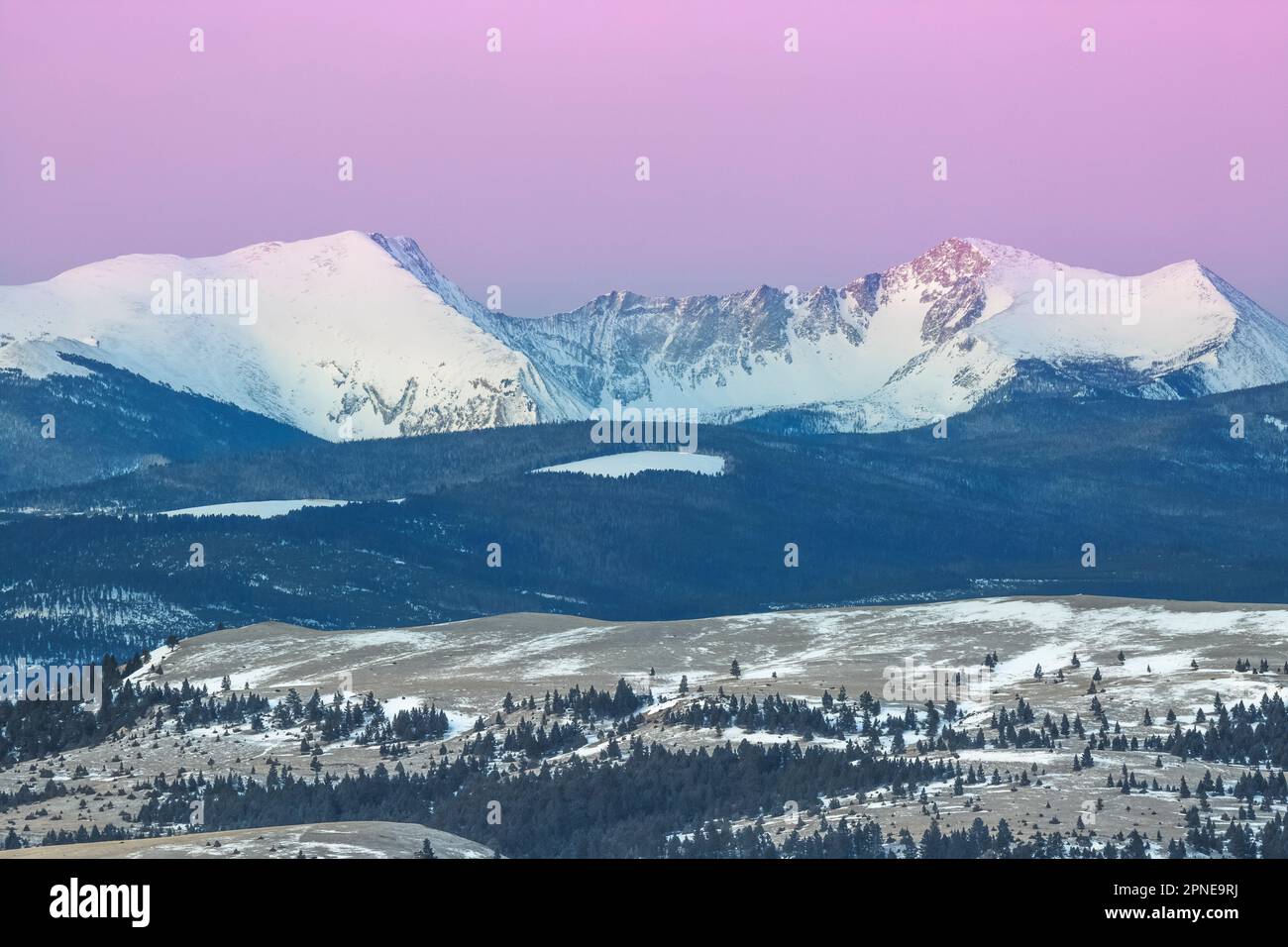 pre-dawn sky over peaks of the flint creek range in winter near ...