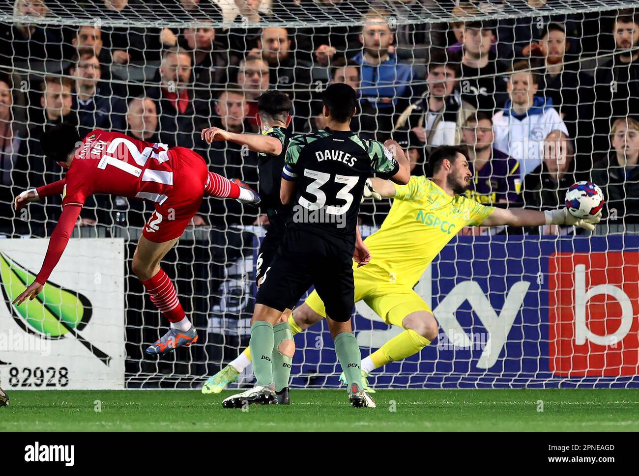 Derby County goalkeeper Joe Wildsmith saves a shot from Exeter City's ...
