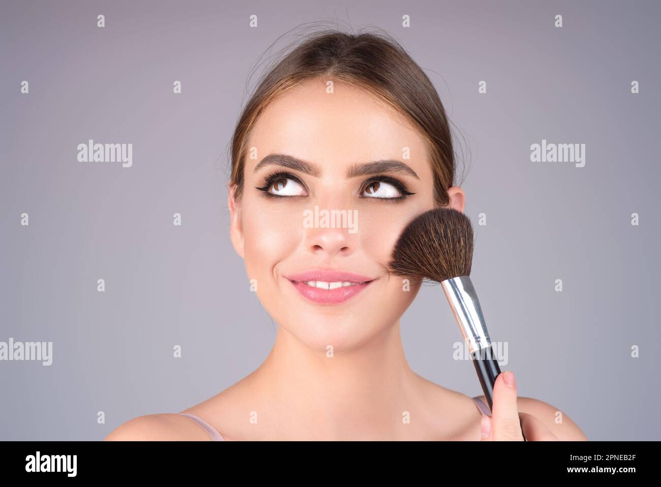 Girl hold blush blusher apply powder visage isolated over studio ...