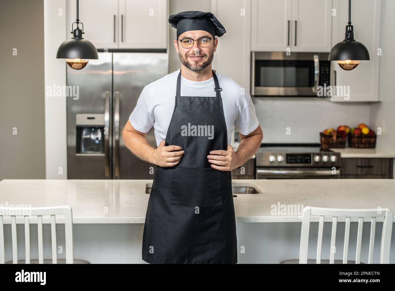 Chef on kitchen. Professional chef man in uniform on kitchen. Bearded ...