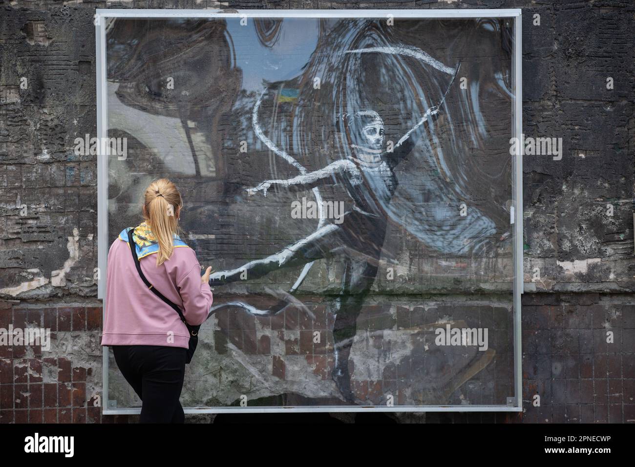 April 17, 2023, Irpin, Ukraine: A woman looks at the graffiti by famous ...