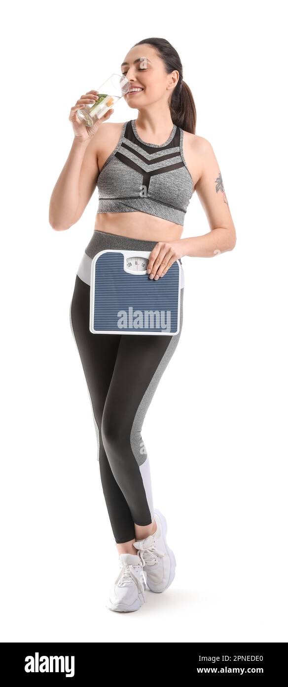 Sporty young woman with scales drinking water on white background Stock ...