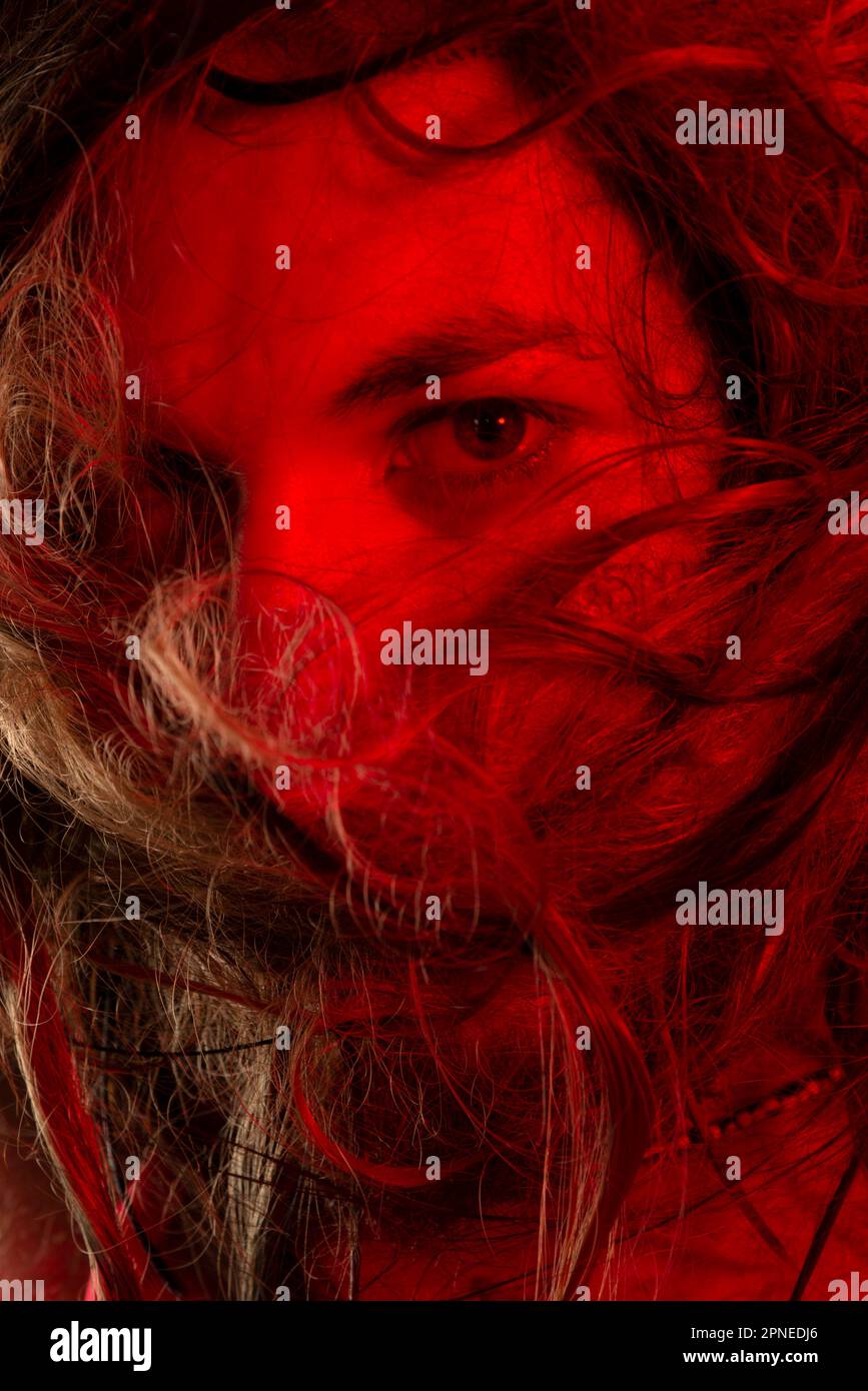 Close-up portrait of handsome young man with hair all over his face ...