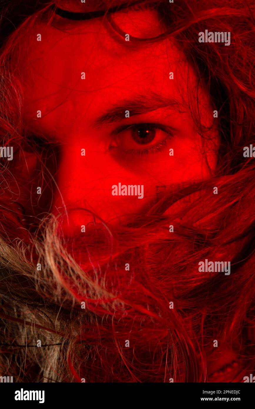 Close-up portrait of handsome young man with hair all over his face ...