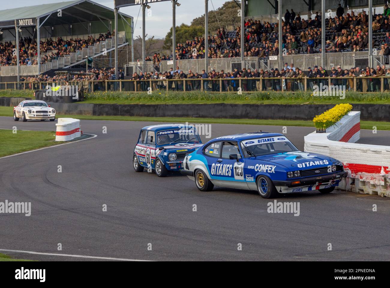 April 2023 - Ford Capri & Mini 1275GT racing close at the Goodwood ...