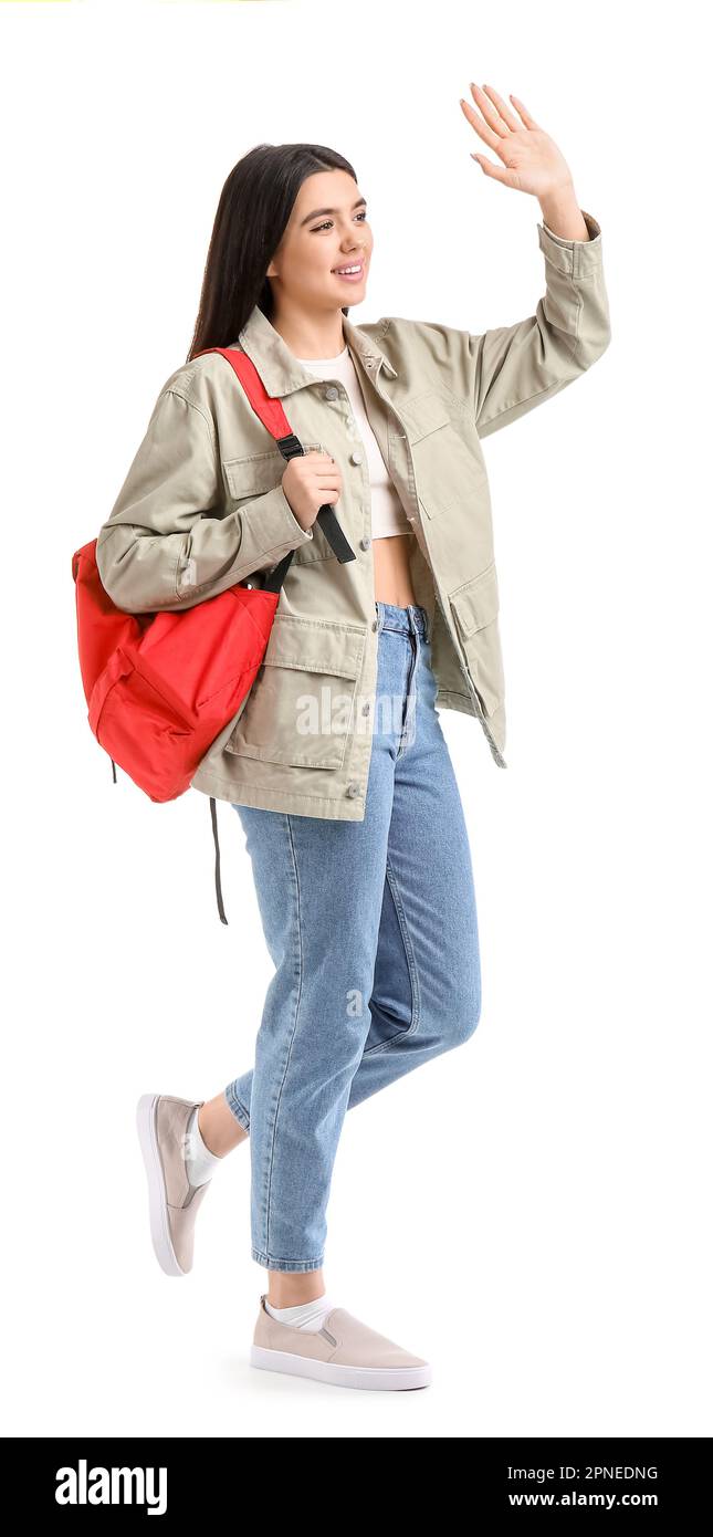 Pretty female student waving hand on white background Stock Photo - Alamy