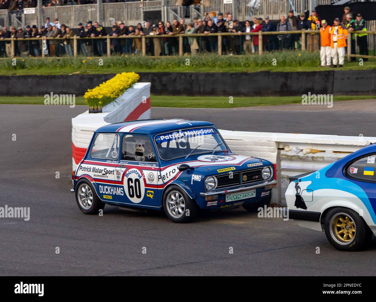 April 2023 - Ford Capri & Mini 1275GT racing close at the Goodwood ...