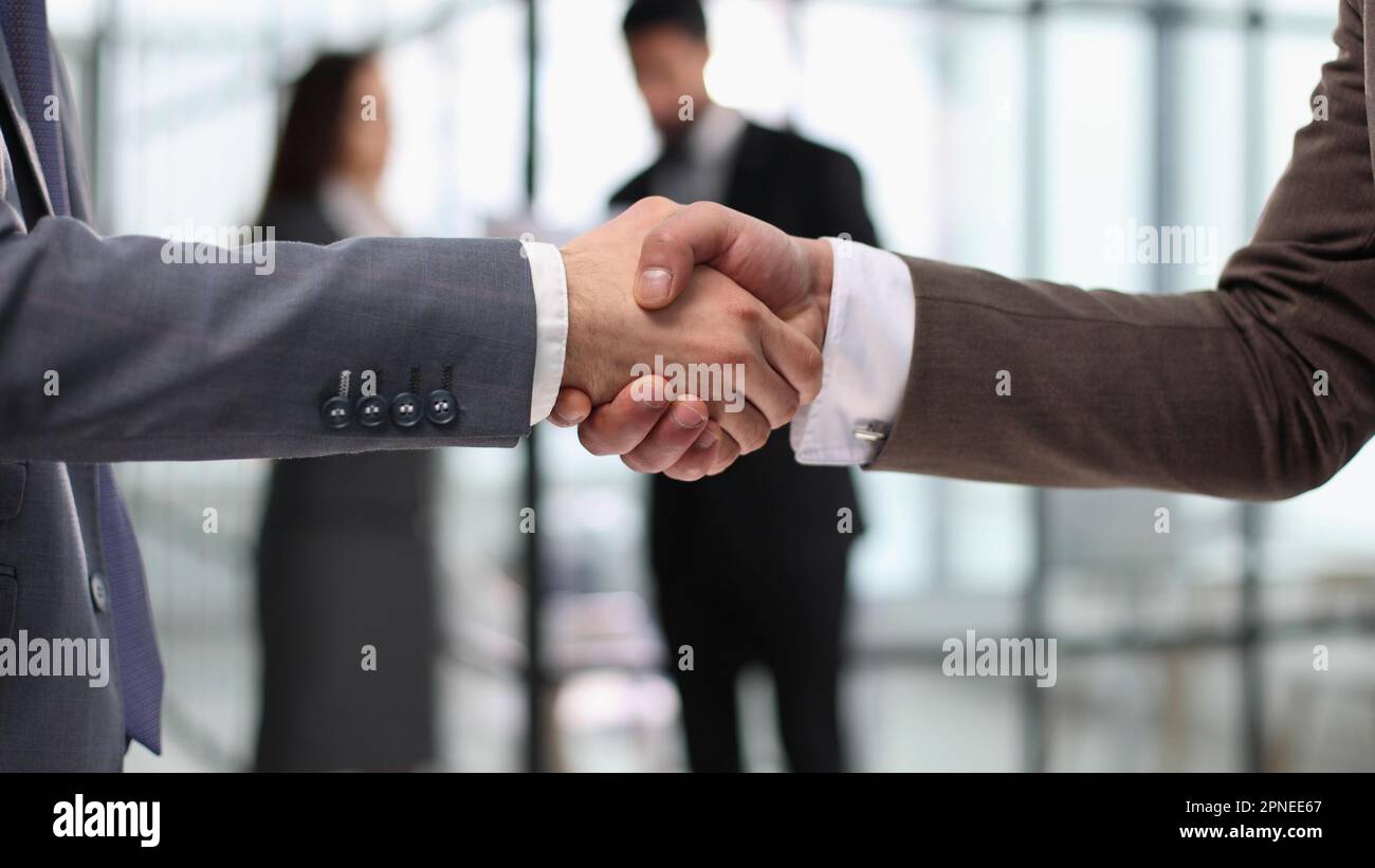 Business partners handshaking close hi-res stock photography and images ...
