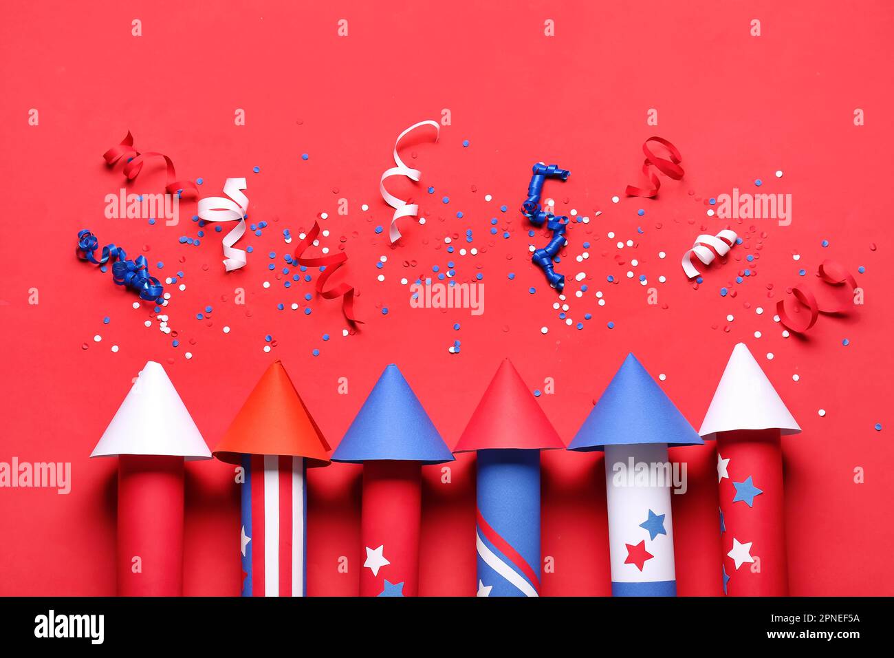 Firework rockets, serpentine and confetti for Independence Day on red ...