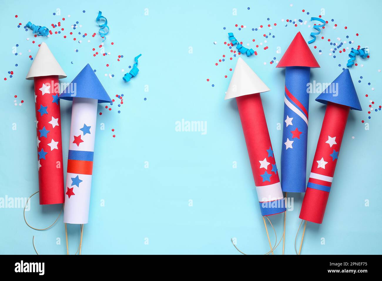 Firework rockets, confetti and serpentine for Independence Day on blue ...