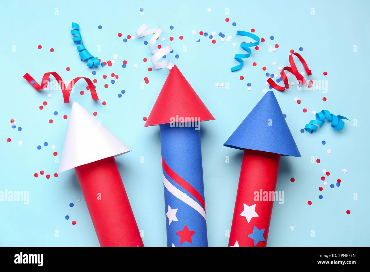 Firework rockets, confetti and serpentine for Independence Day on blue ...