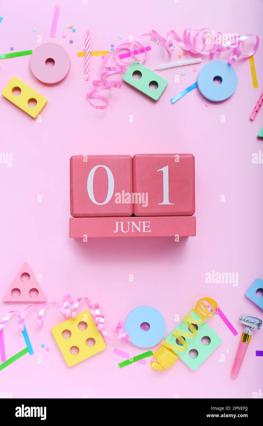 Cube calendar with date 01 JUNE, baby blocks and confetti on pink ...