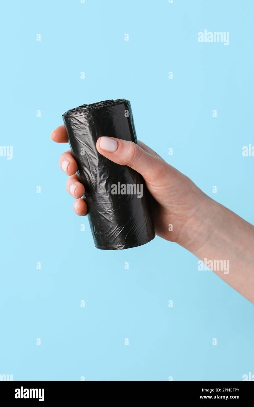 Hand holding garbage bags hi-res stock photography and images - Alamy