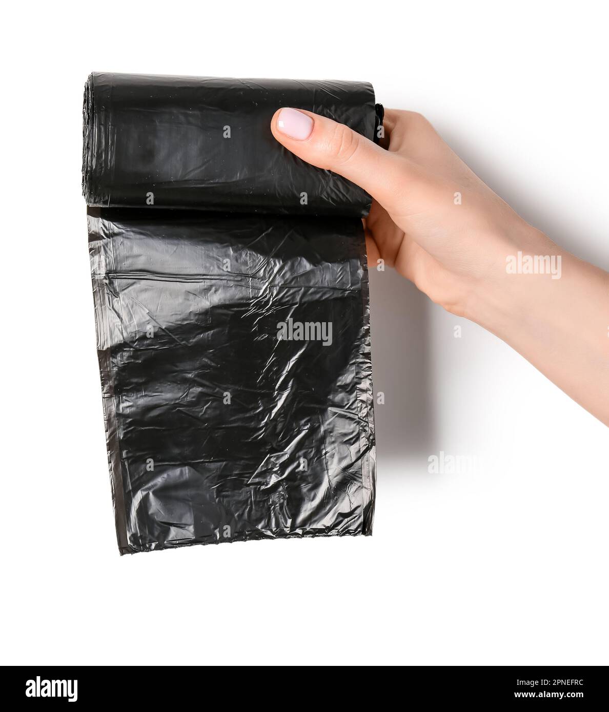 Female hand holding roll of garbage bags on white background Stock ...