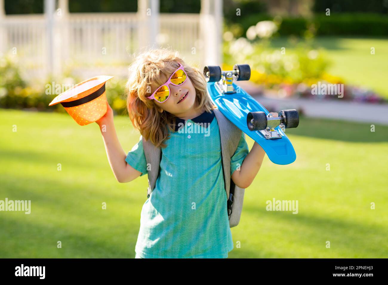 Child boy holding longboard on pink background. Kid with pennyboard ...