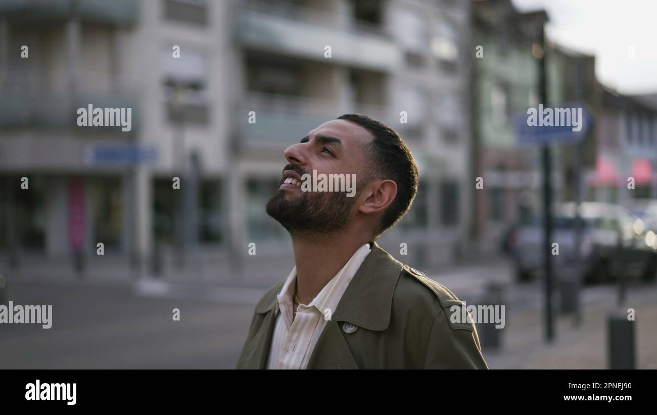 Portrait of a pensive happy Middle Eastern Man gazing at sky with ...