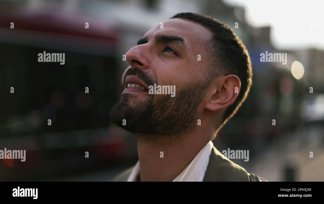 Portrait of a pensive happy Middle Eastern Man gazing at sky with ...