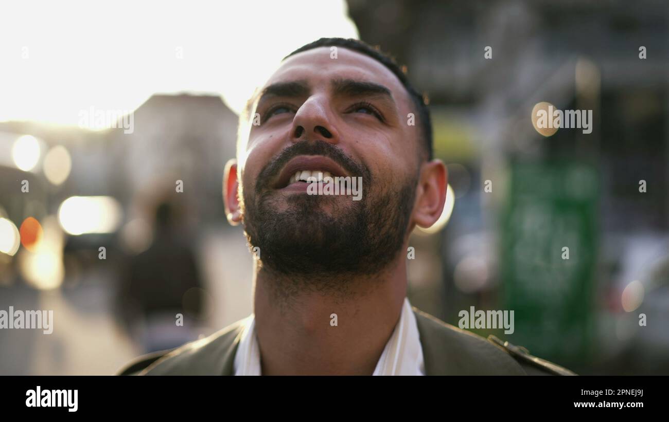 Portrait of a pensive happy Middle Eastern Man gazing at sky with ...