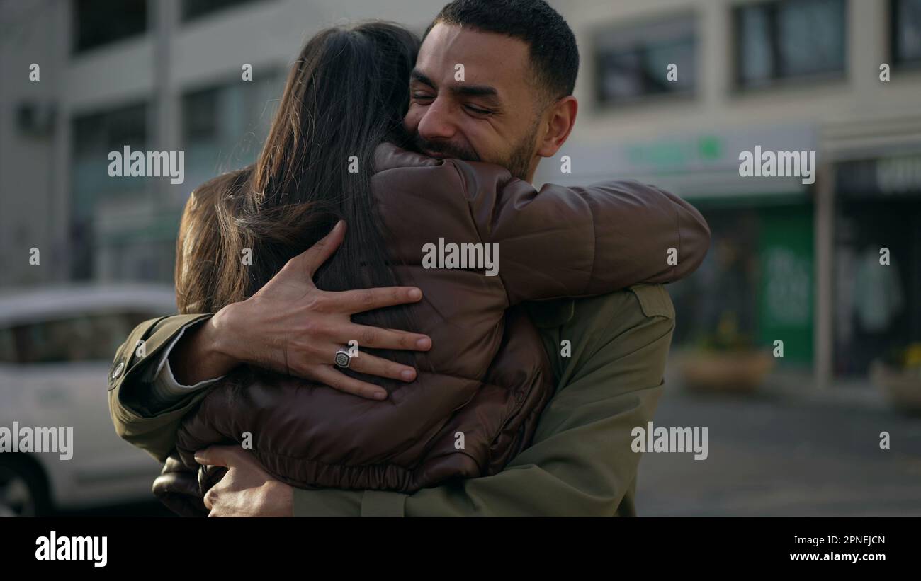 Two friends hug and embrace outside, real life happiness reunion. A ...